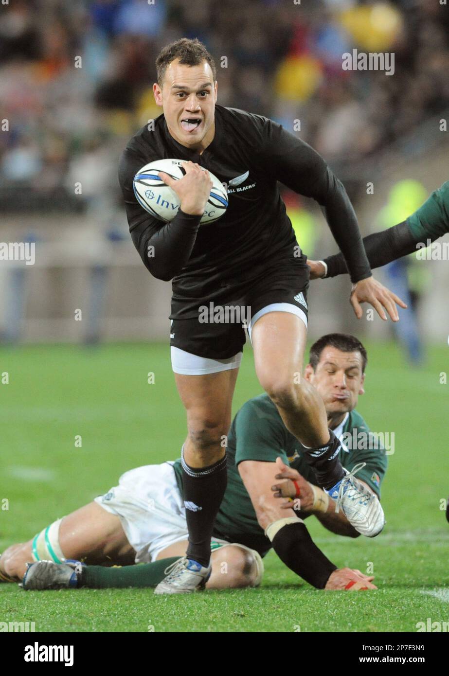 New Zealand's Israel Dagg runs past the tackle of South Africa's Pierre ...
