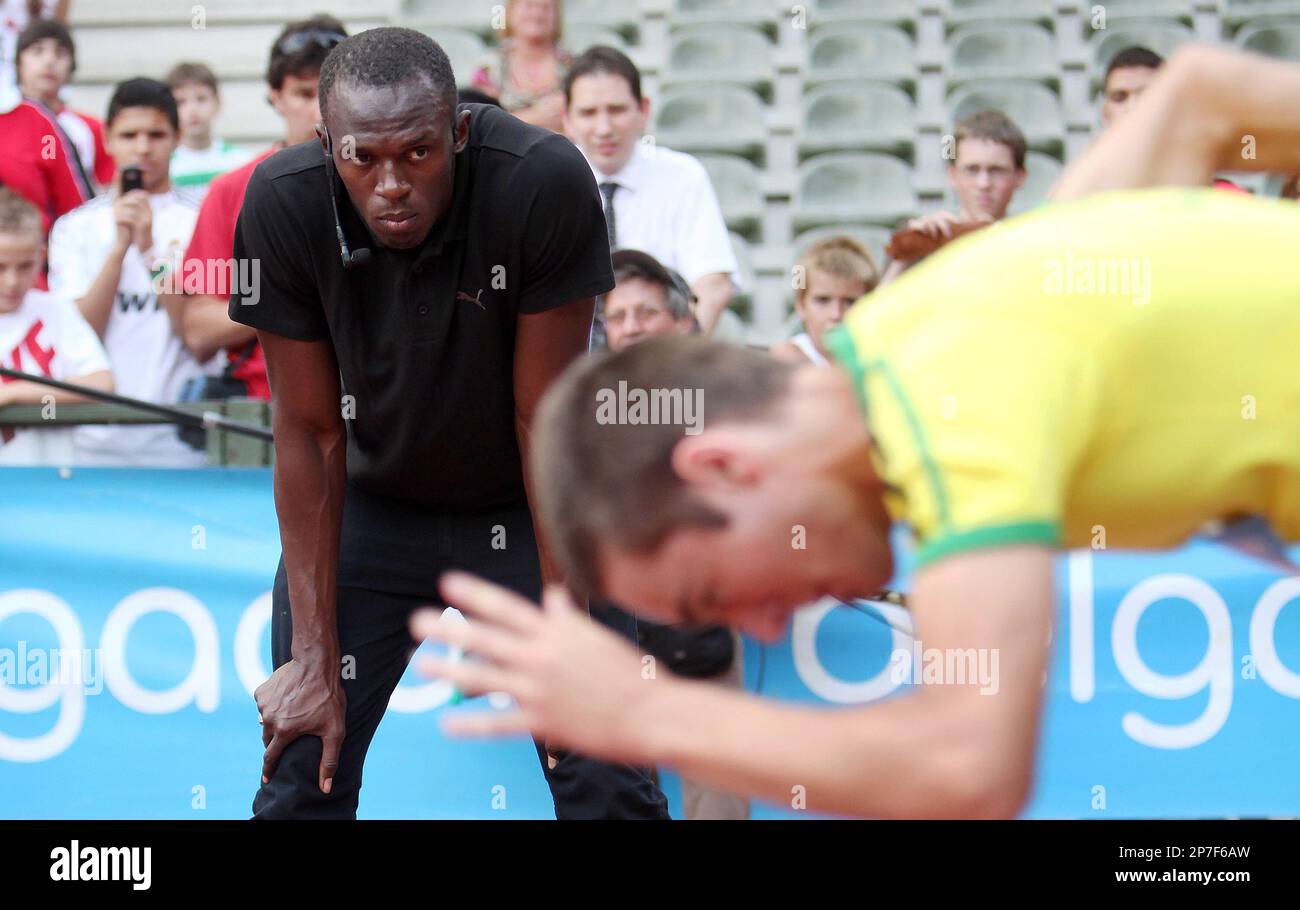 Jamaican sprinter Usain Bolt attends a practice session with 500 young ...