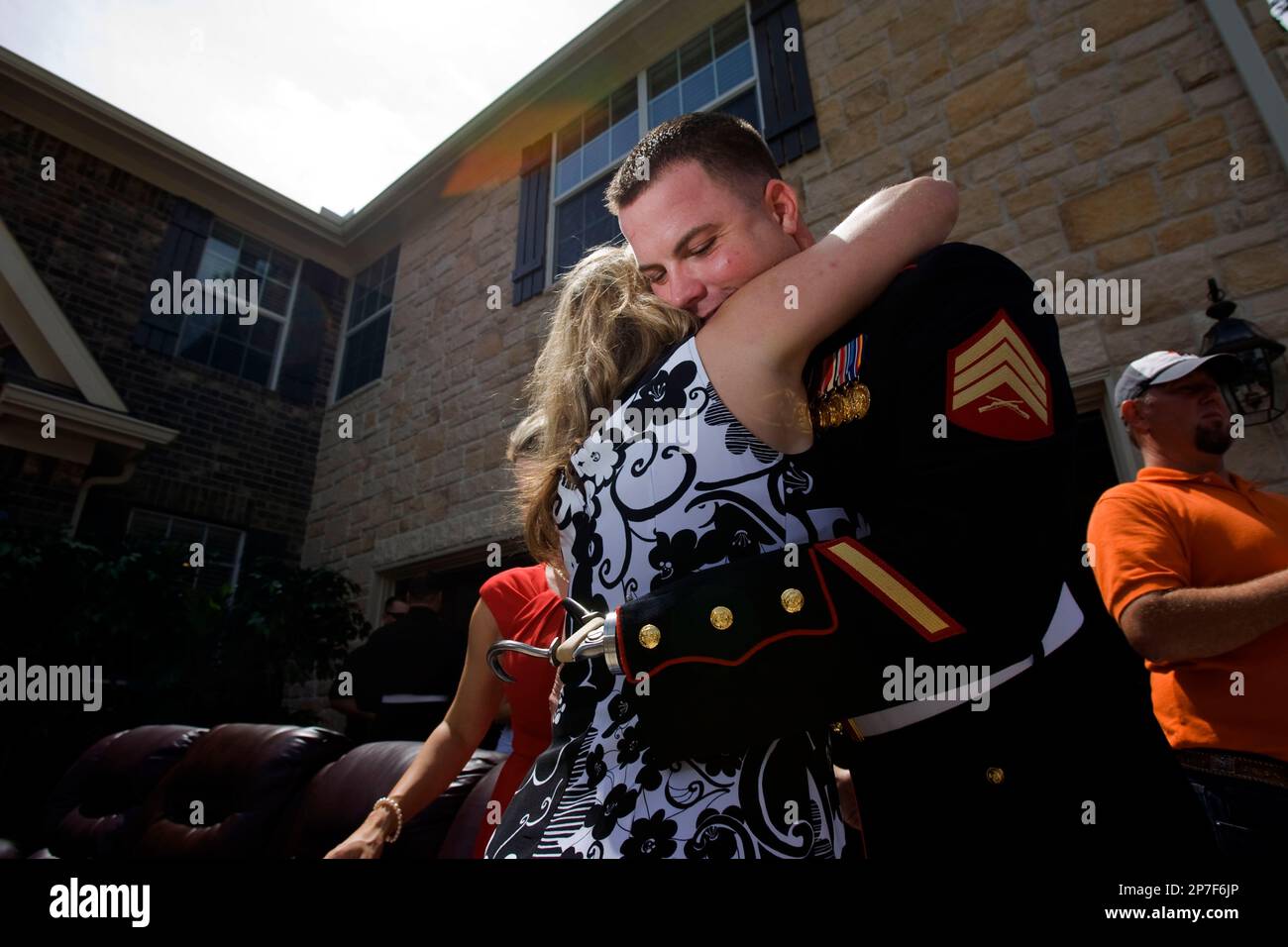 U.S. Marine Sgt. James "Eddie" Wright gets a hug from Theresa Scheib of ...