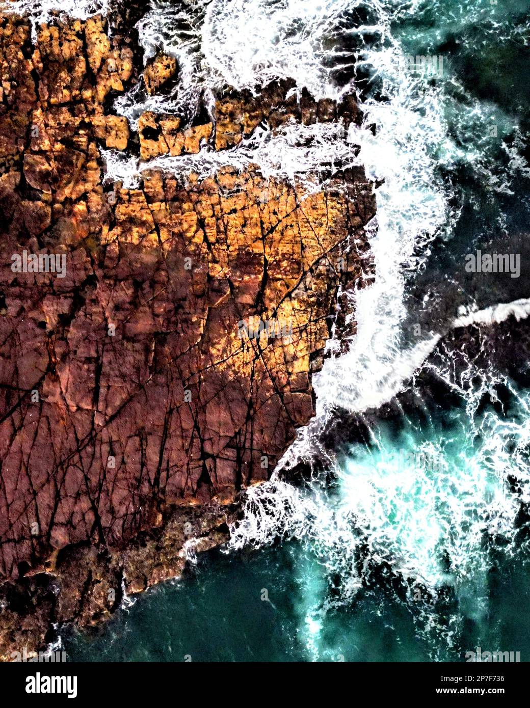 A tranquil scene of waves crashing against rocks near the shore ...