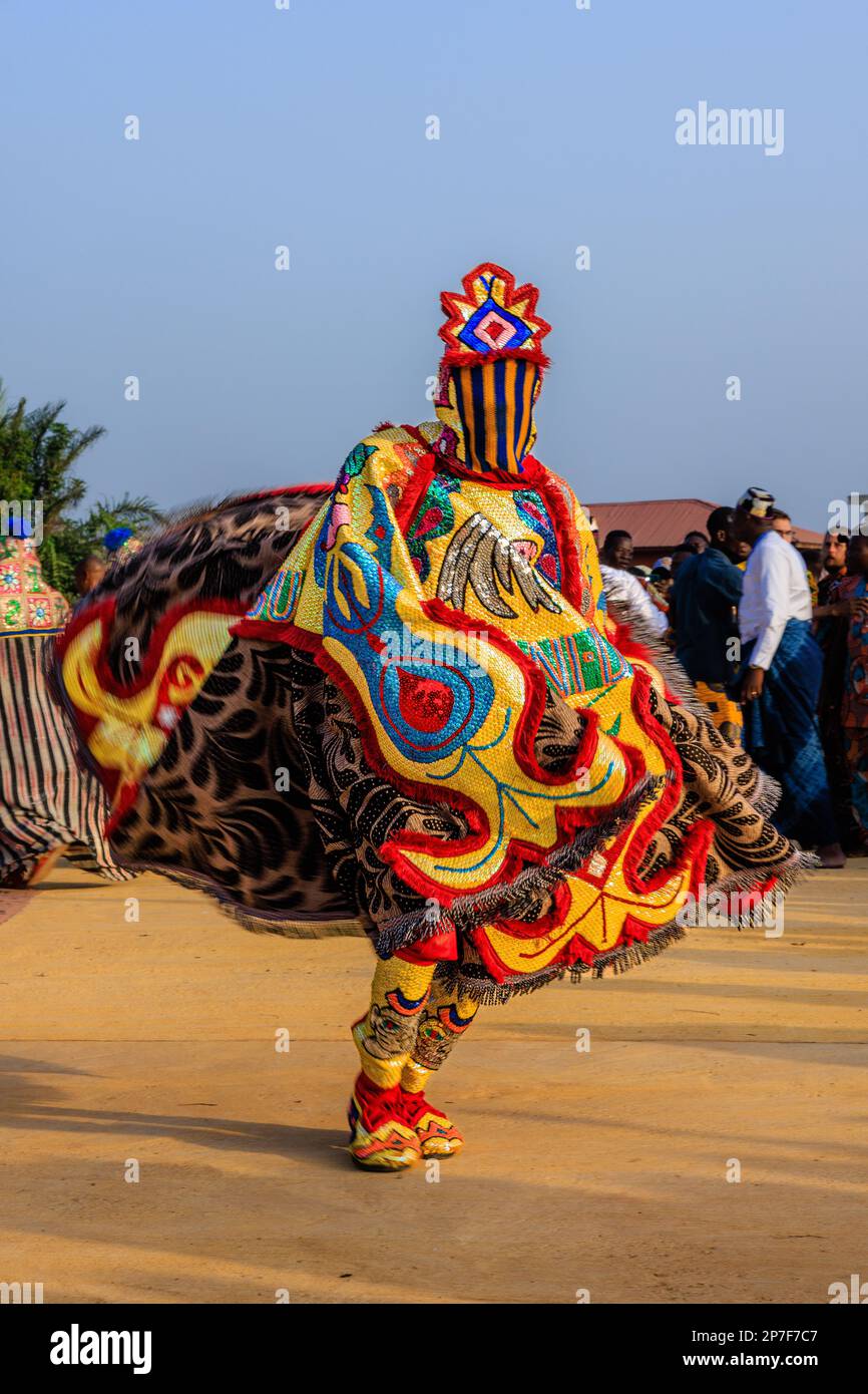 brightly costumed eguinguin invokes ancestral spirits in a whirling ...