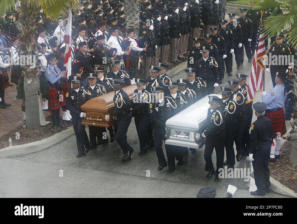 The funeral detail carries the caskets officers David Curtis and ...
