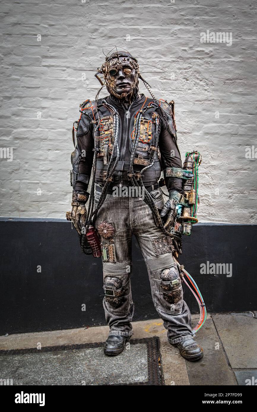 A cyberpunk covered with technology staring directly into camera ...