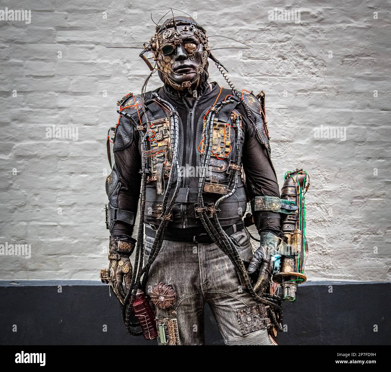 A cyberpunk covered with technology staring directly into camera ...