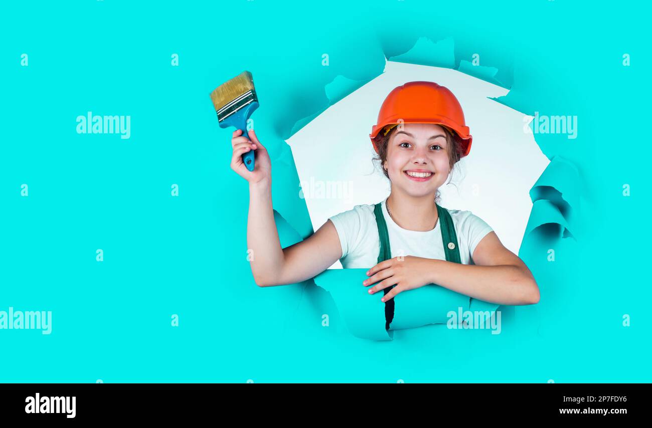 girl in protective helmet painting the wall. childhood development. Kid ...