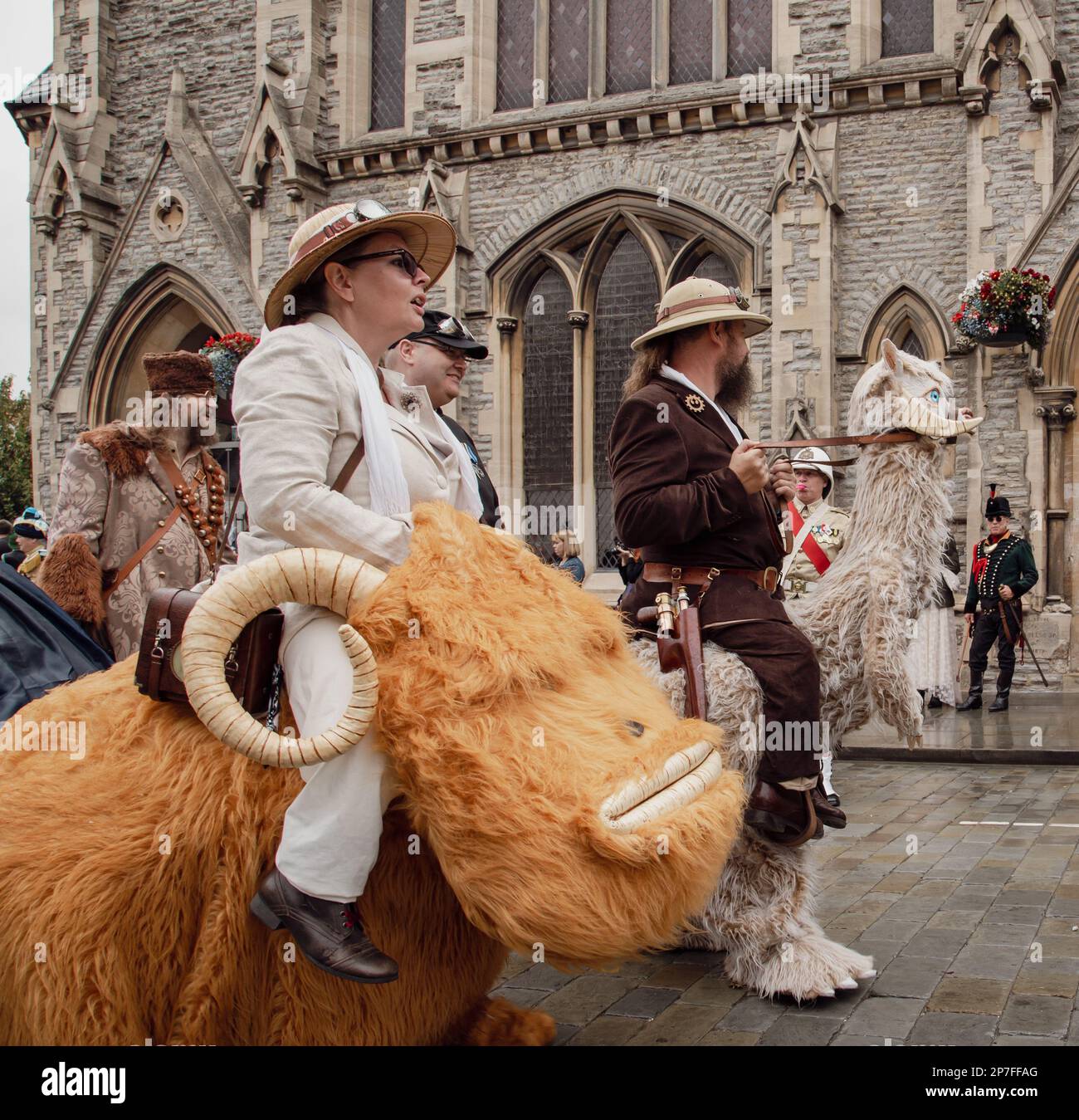 Steampunks riding fantasy animals in s street procession Stock Photo ...