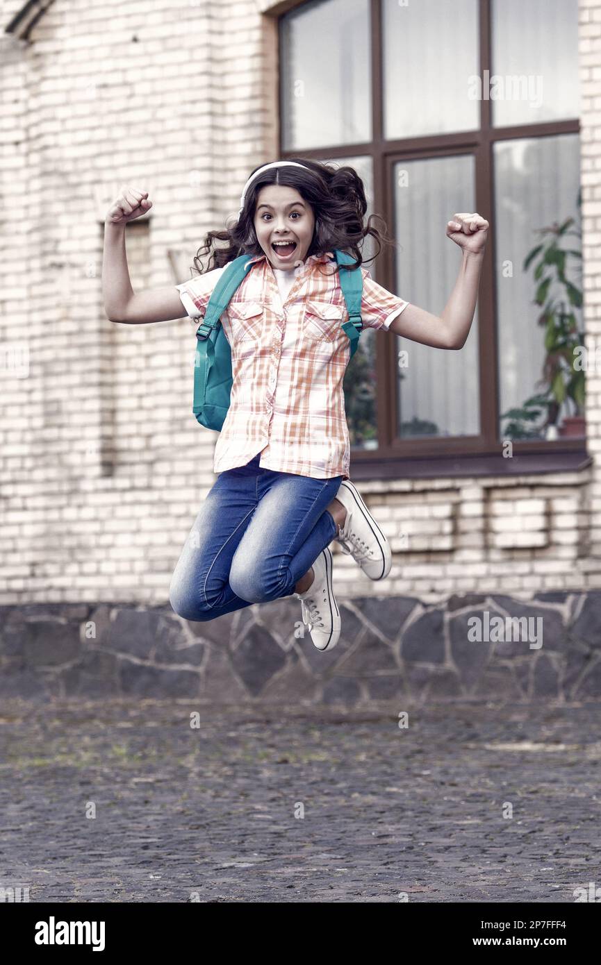 Aim high, together we will fly. Happy child jump outdoors. Active ...