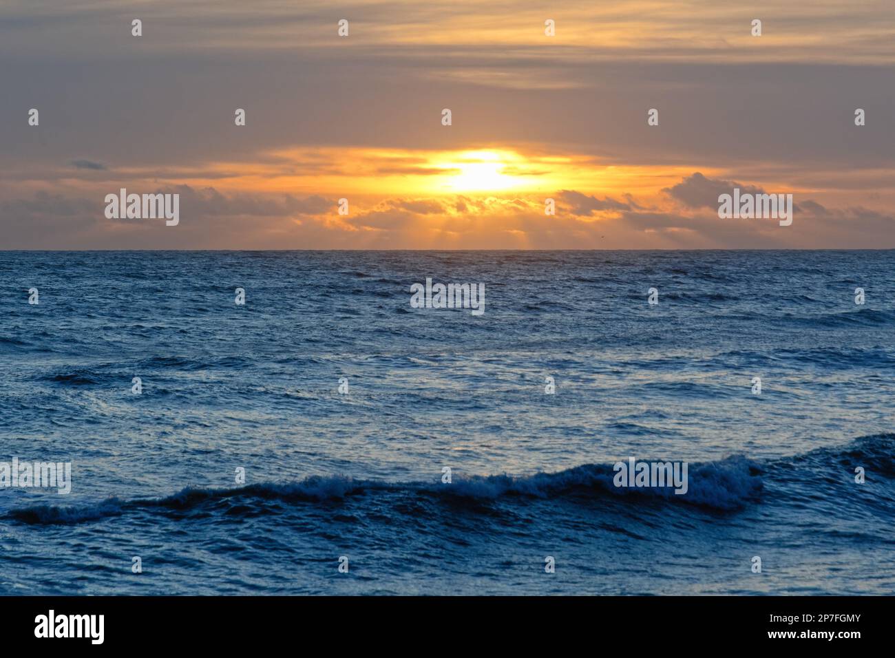 A winter sunset over an empty sea and horizon at Worthing West Sussex ...