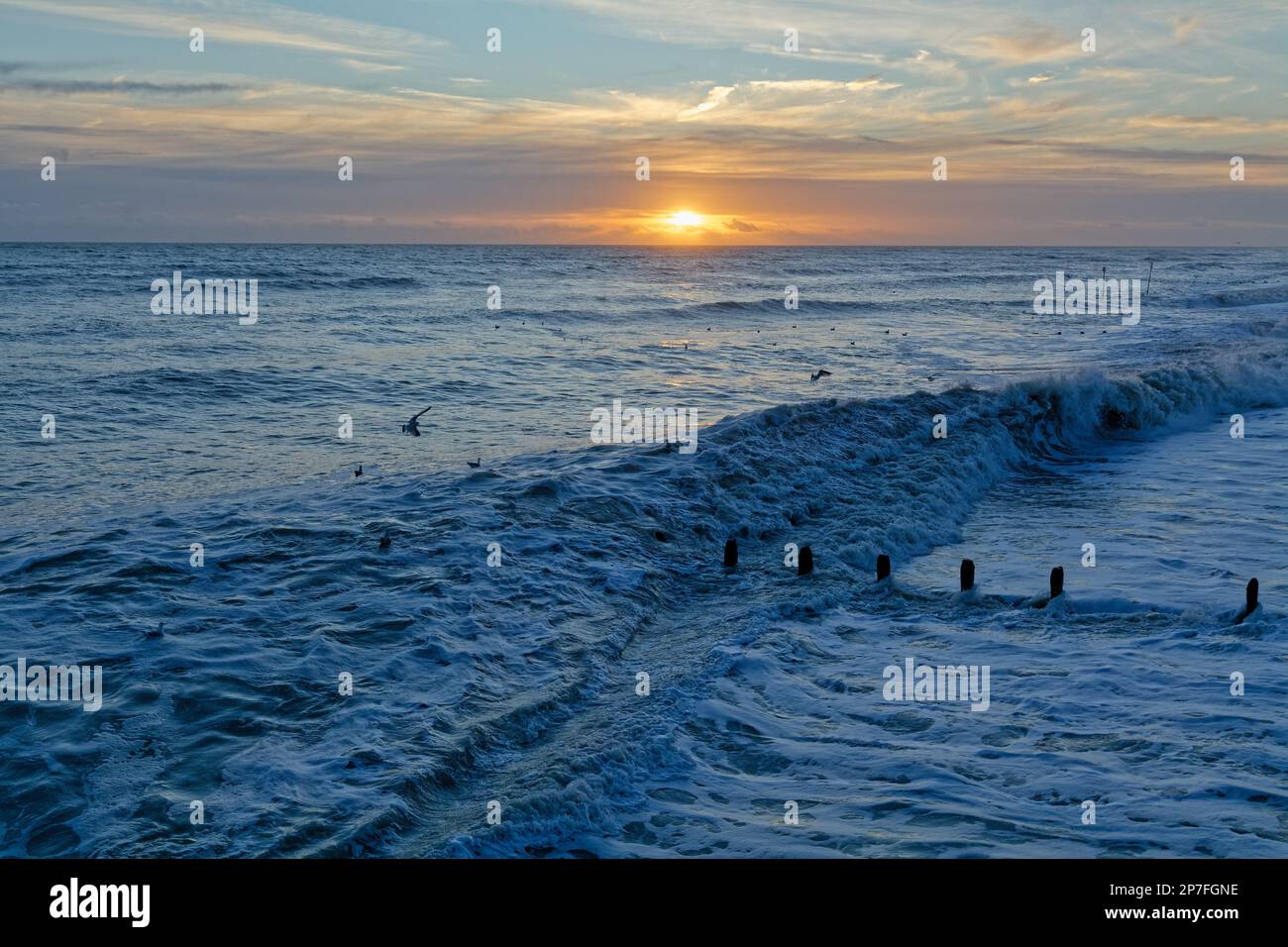 A winter sunset over an empty sea and horizon at Worthing West Sussex ...