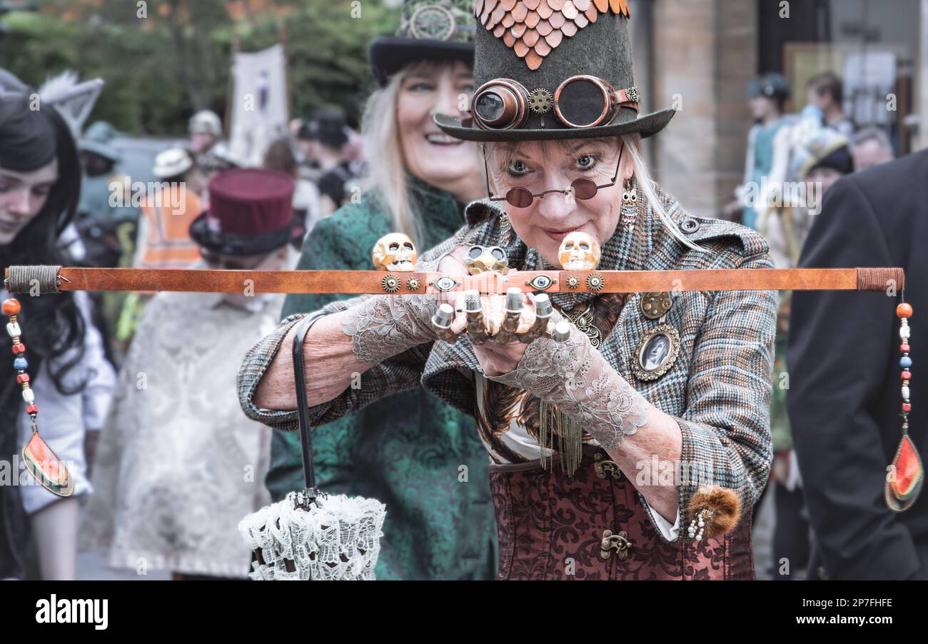 A female steampunk with a crossbow taking aim directly at the camera ...