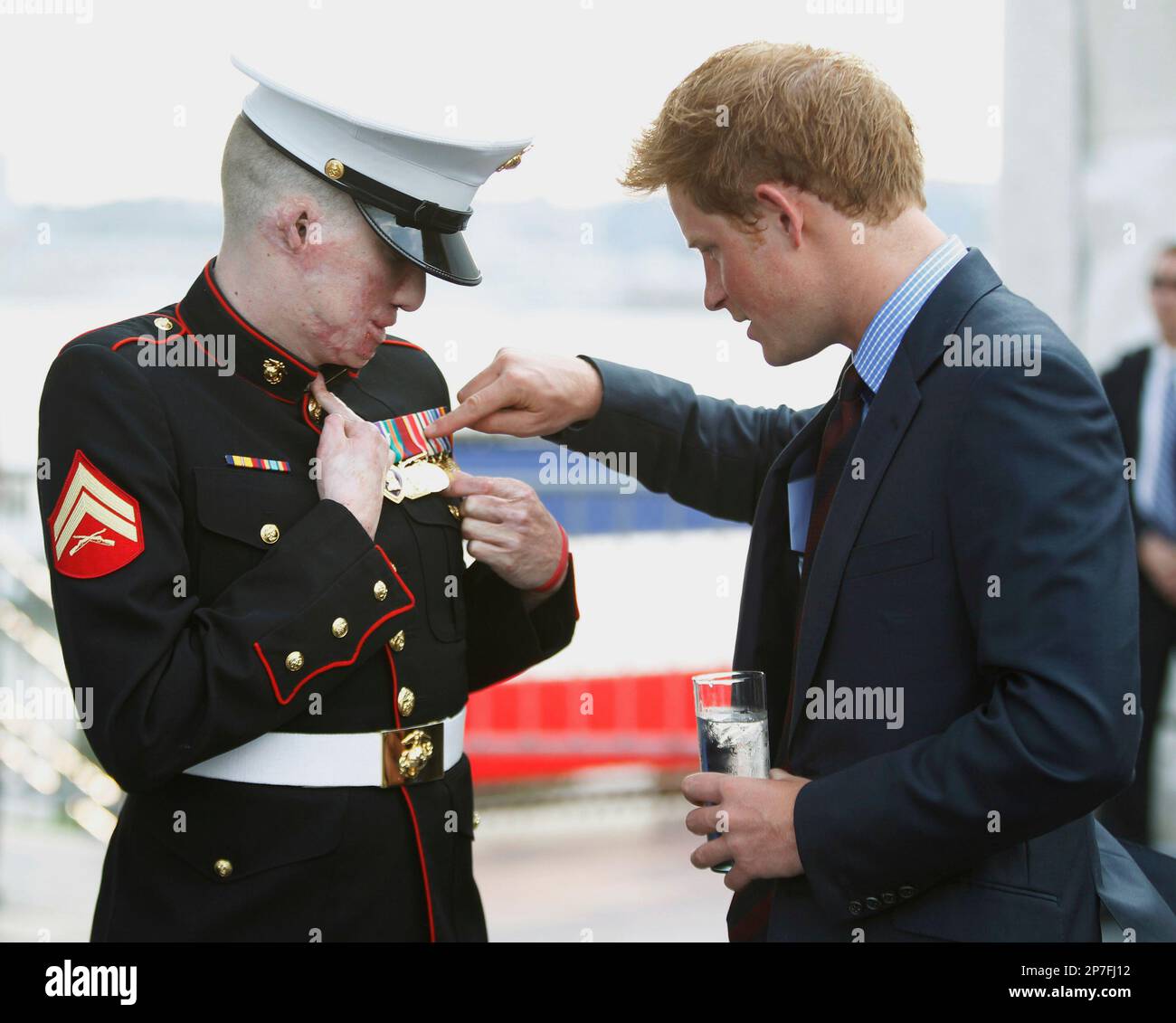Britain's Prince Harry, right, speaks with U.S. Marine veteran Aaron ...