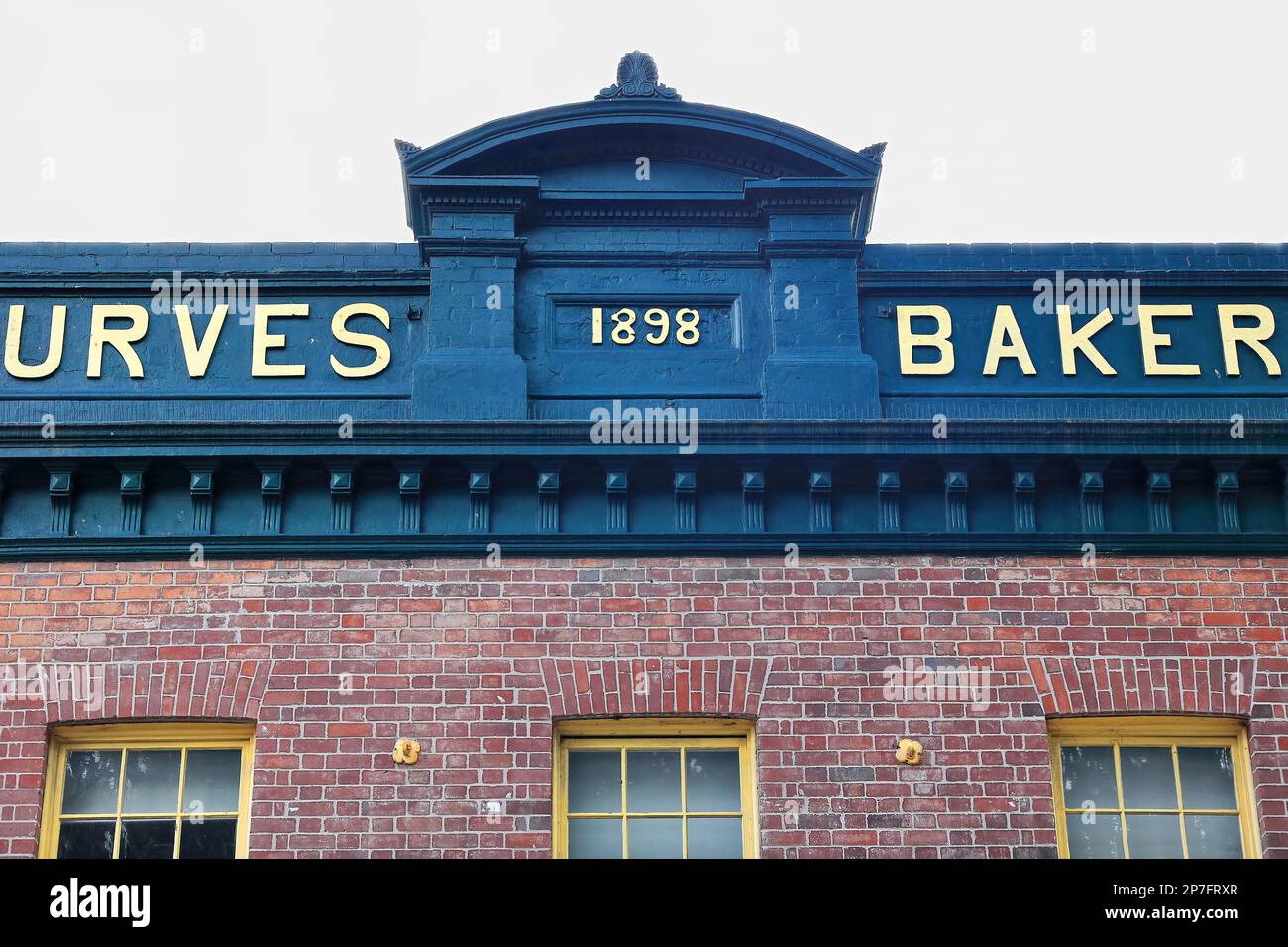 536 Name in gold on blue of a long ago closed business atop the red ...