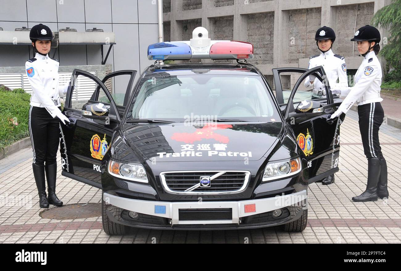 Traffic policewomen stand next to a luxury Volvo police car in ...
