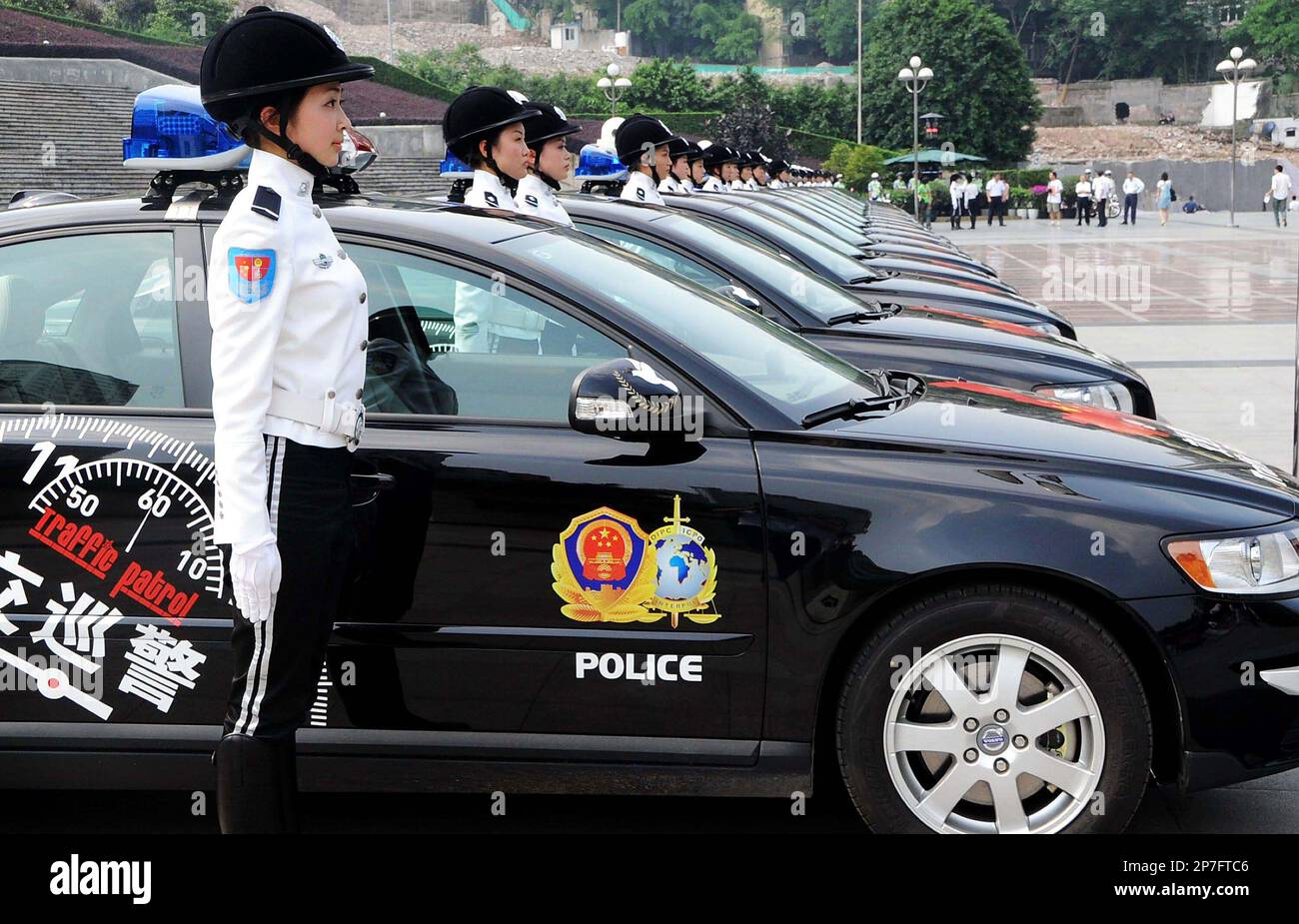 Traffic policewomen stand next to luxury Volvo police cars in southwest ...