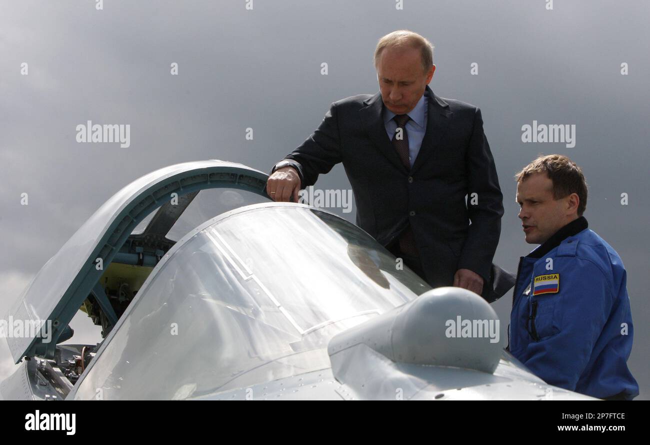 Russian Prime Minister Vladimir Putin, left, flanked by test pilot ...