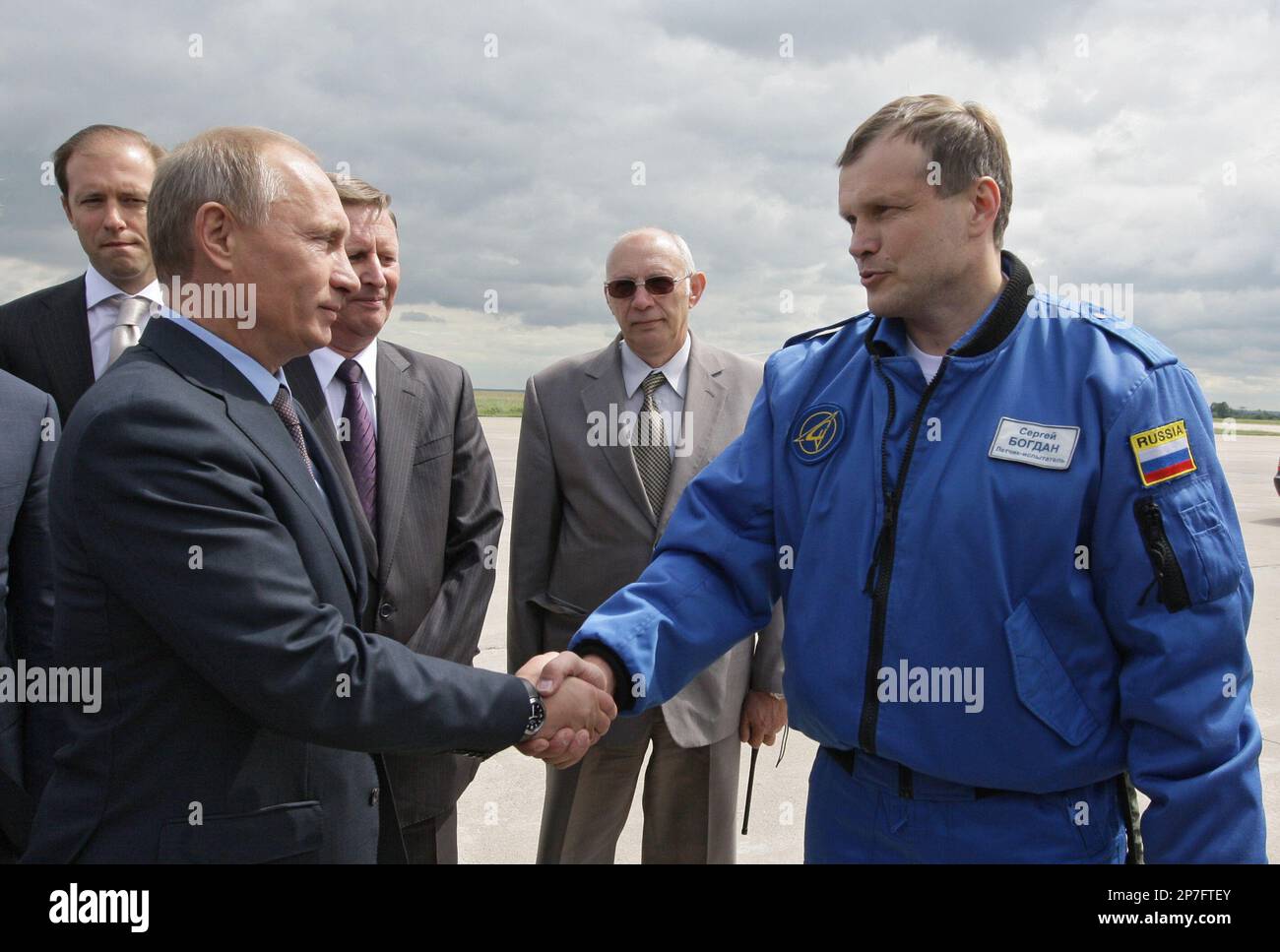 Russian Prime Minister Vladimir Putin, left, shakes hands with test ...
