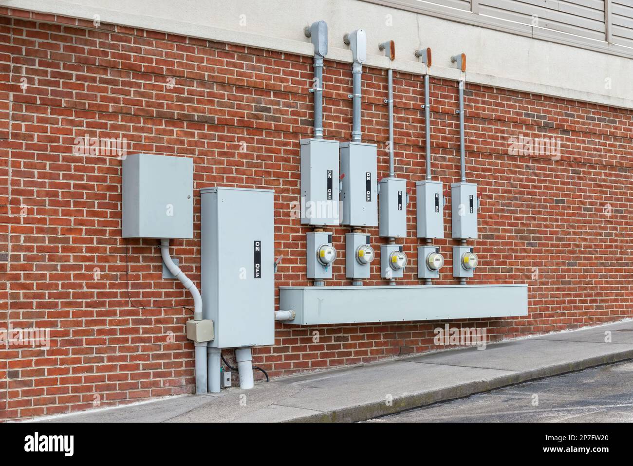 Horizontal shot of electric meters and breakers on the end of a retail ...
