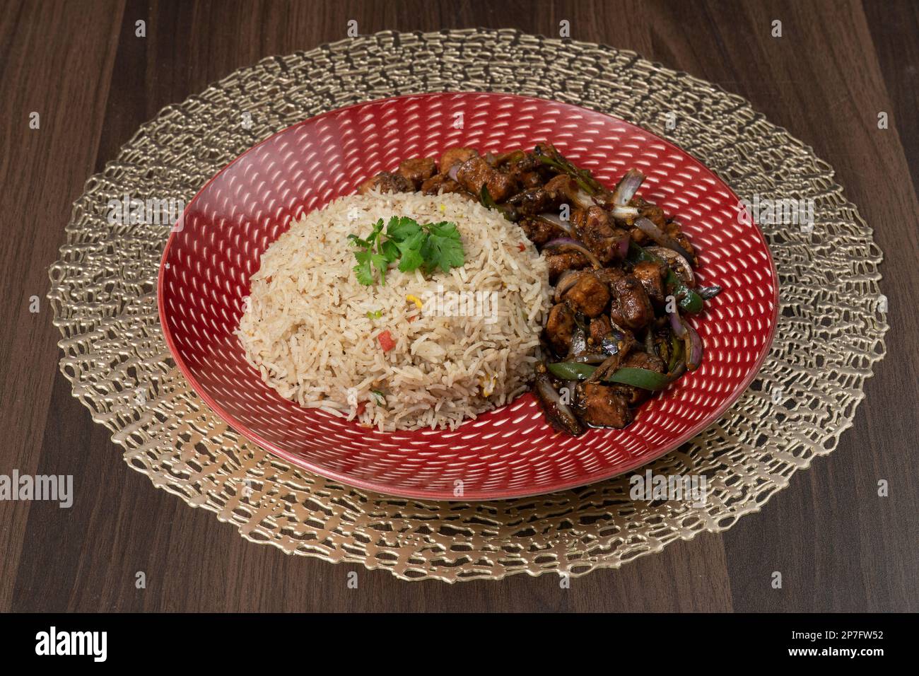 Chicken dry chili with a bowl of fried rice on textured background ...
