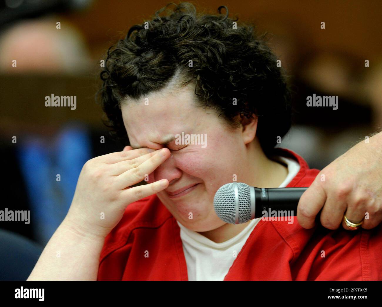 Melissa Huckaby, 29, of Tracy, Calif. wipes her eyes as she reads a ...