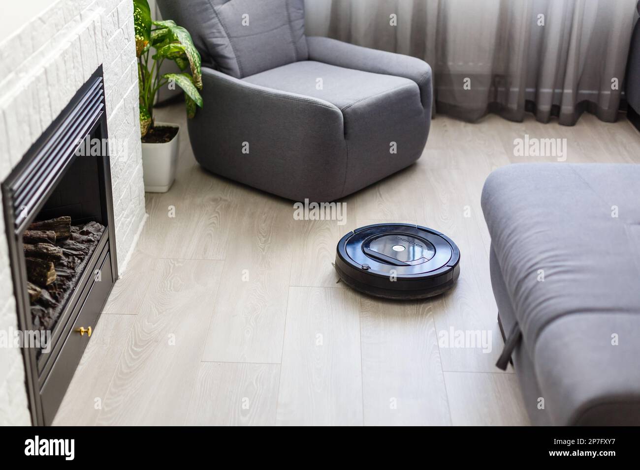 Robotic vacuum cleaner cleaning the room Stock Photo - Alamy