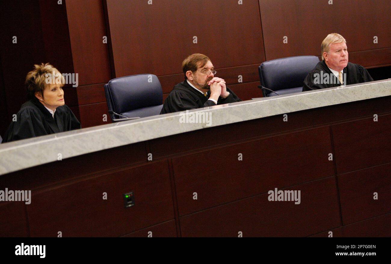 Nevada Supreme Court Justices, from left, Nancy Saitta, Michael Cherry and Mark Gibbons listen ...
