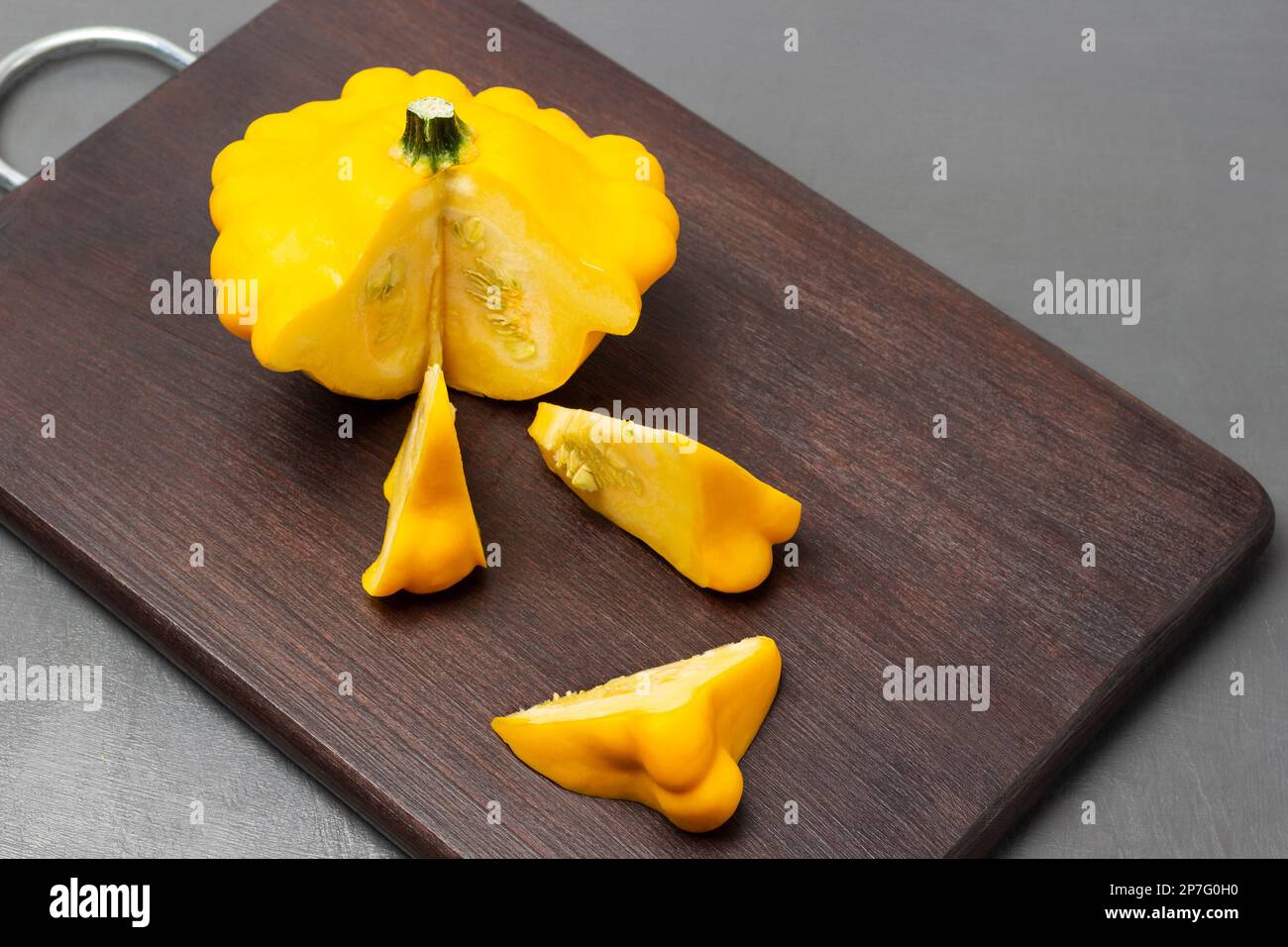Yellow round zucchini and zucchini slices on a cutting board. Top view ...
