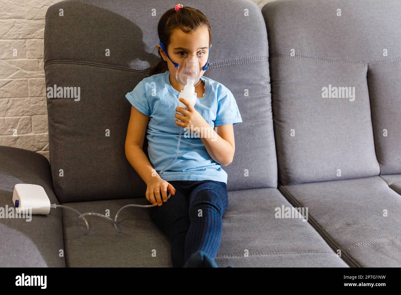 Little girl making inhalation with nebulizer at home. child asthma ...