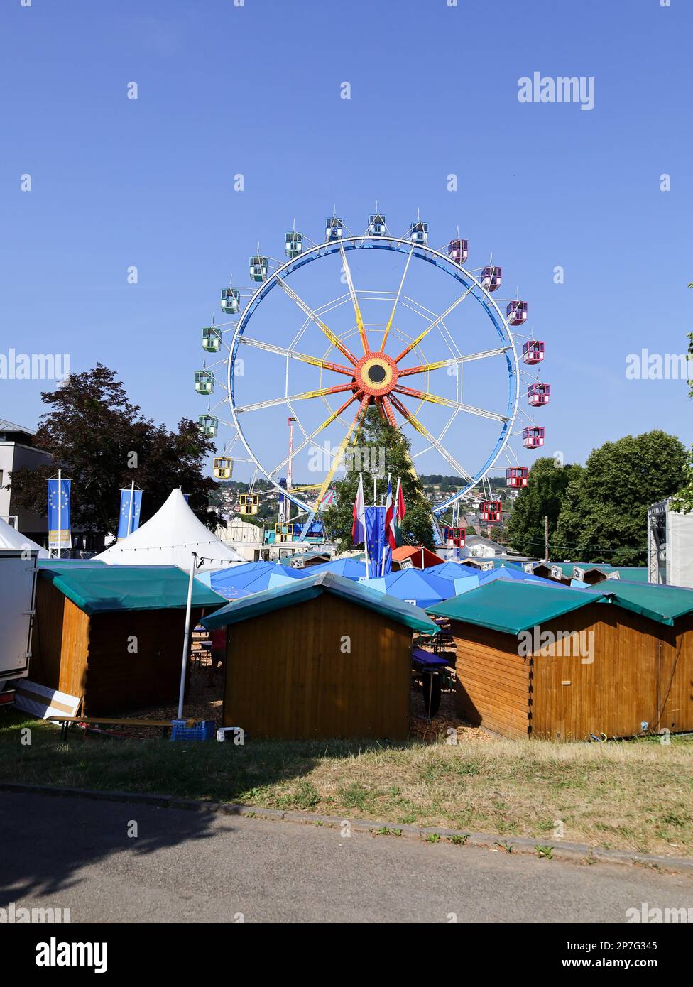 colorful booths and fun rides at a fairground Stock Photo - Alamy