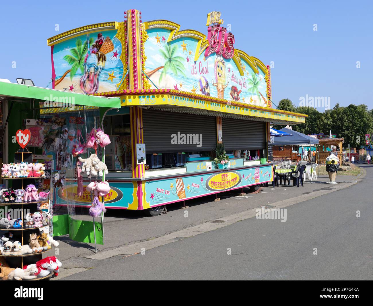 colorful booths and fun rides at a fairground Stock Photo - Alamy