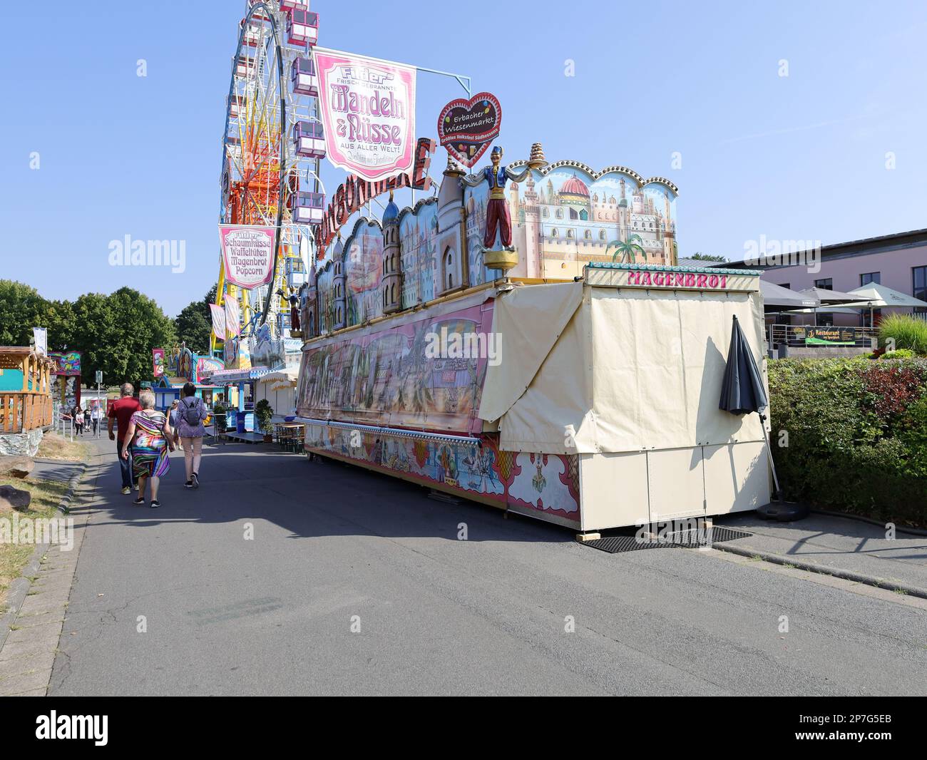 colorful booths and fun rides at a fairground Stock Photo - Alamy