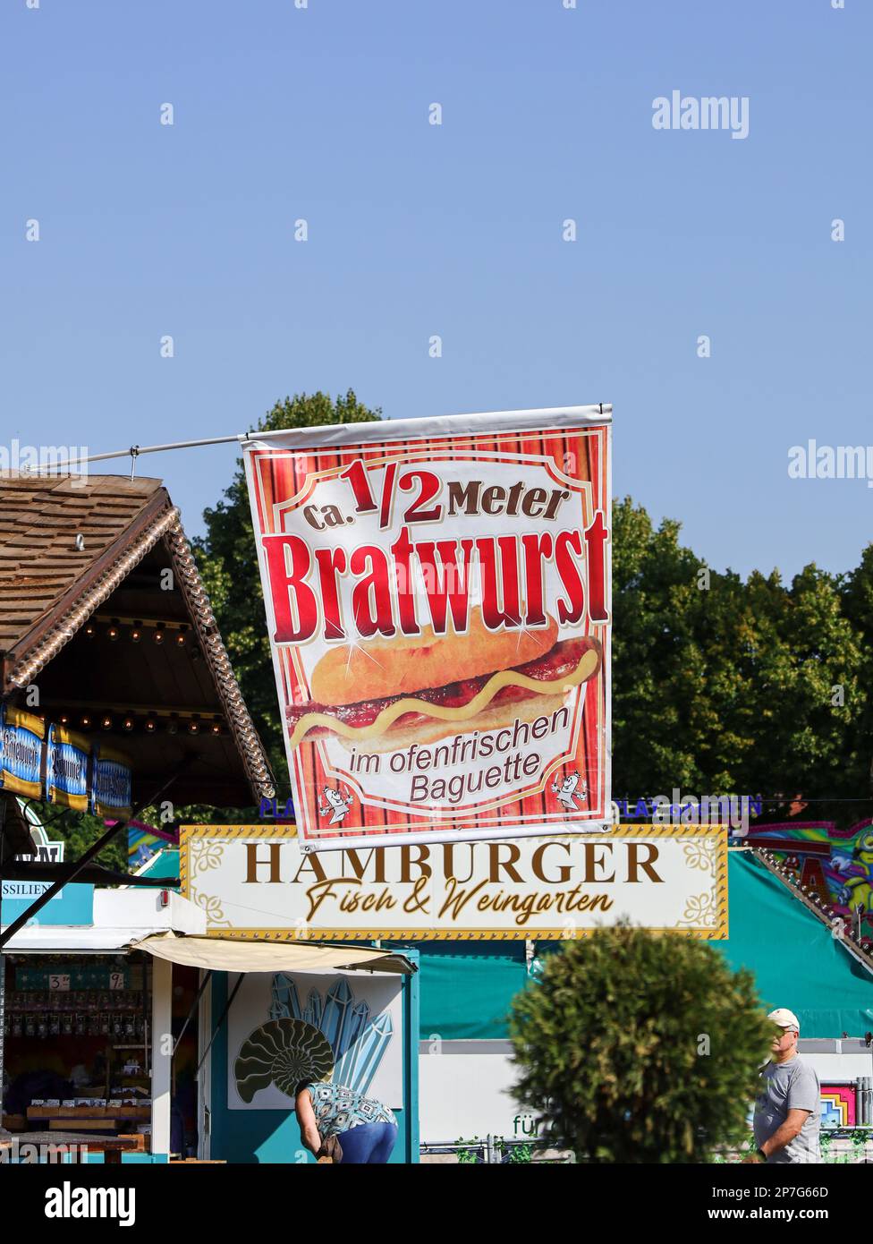 colorful booths and fun rides at a fairground Stock Photo - Alamy