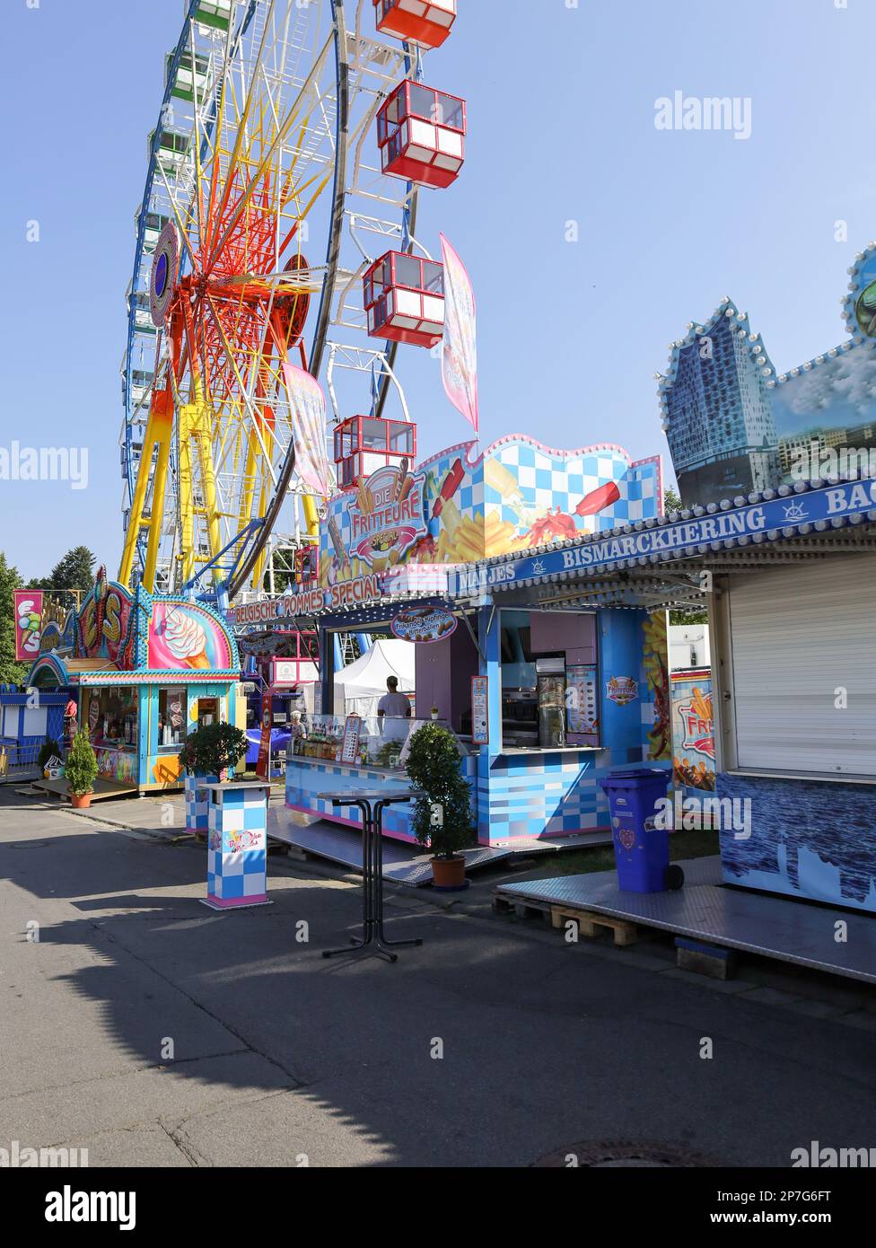 colorful booths and fun rides at a fairground Stock Photo - Alamy