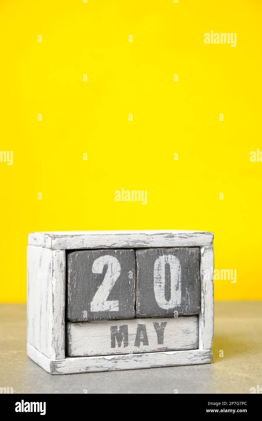 May 20 calendar made wooden cubes yellow background.With an empty space ...