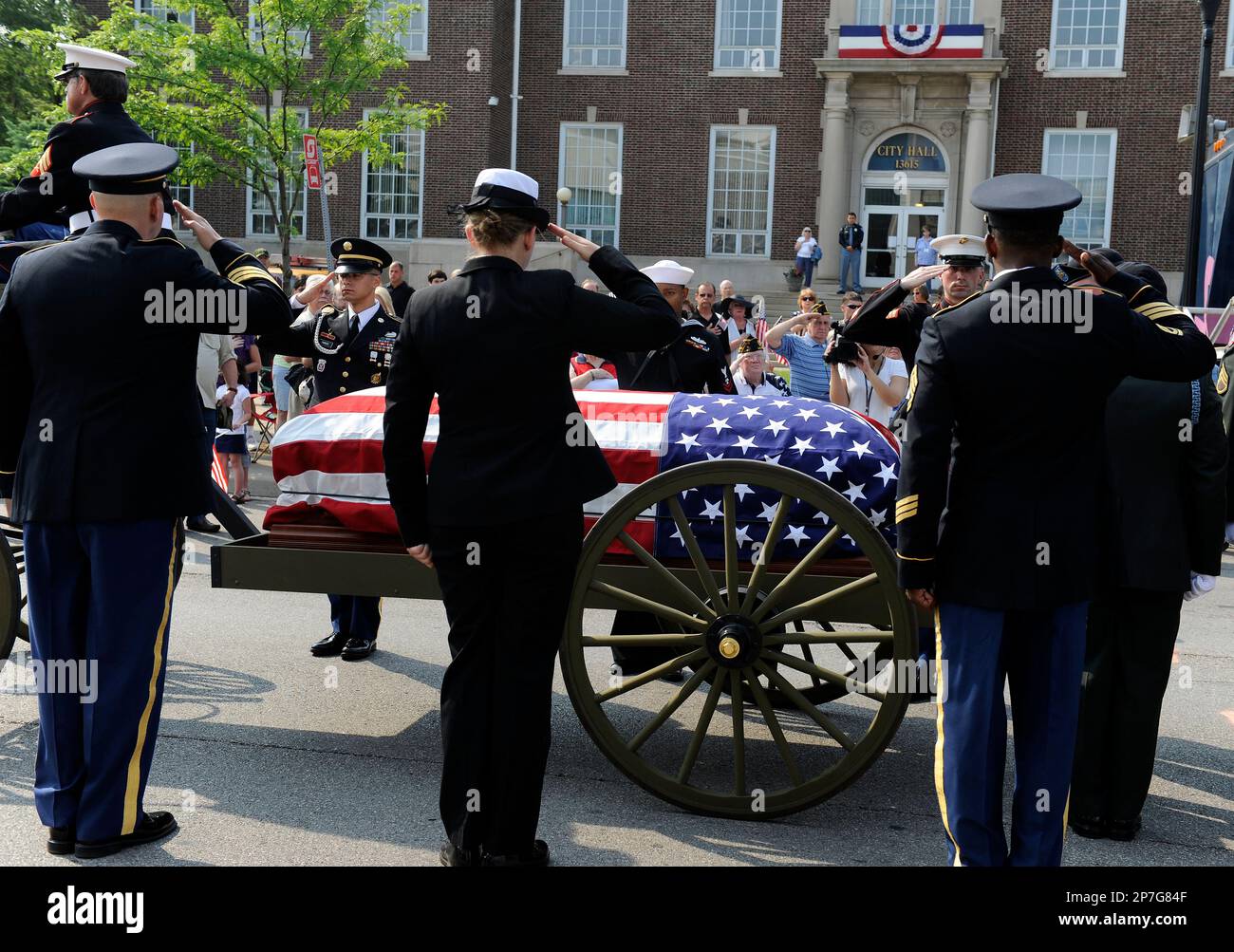 The casket carrying the cremated remains of a veteran is saluted during ...