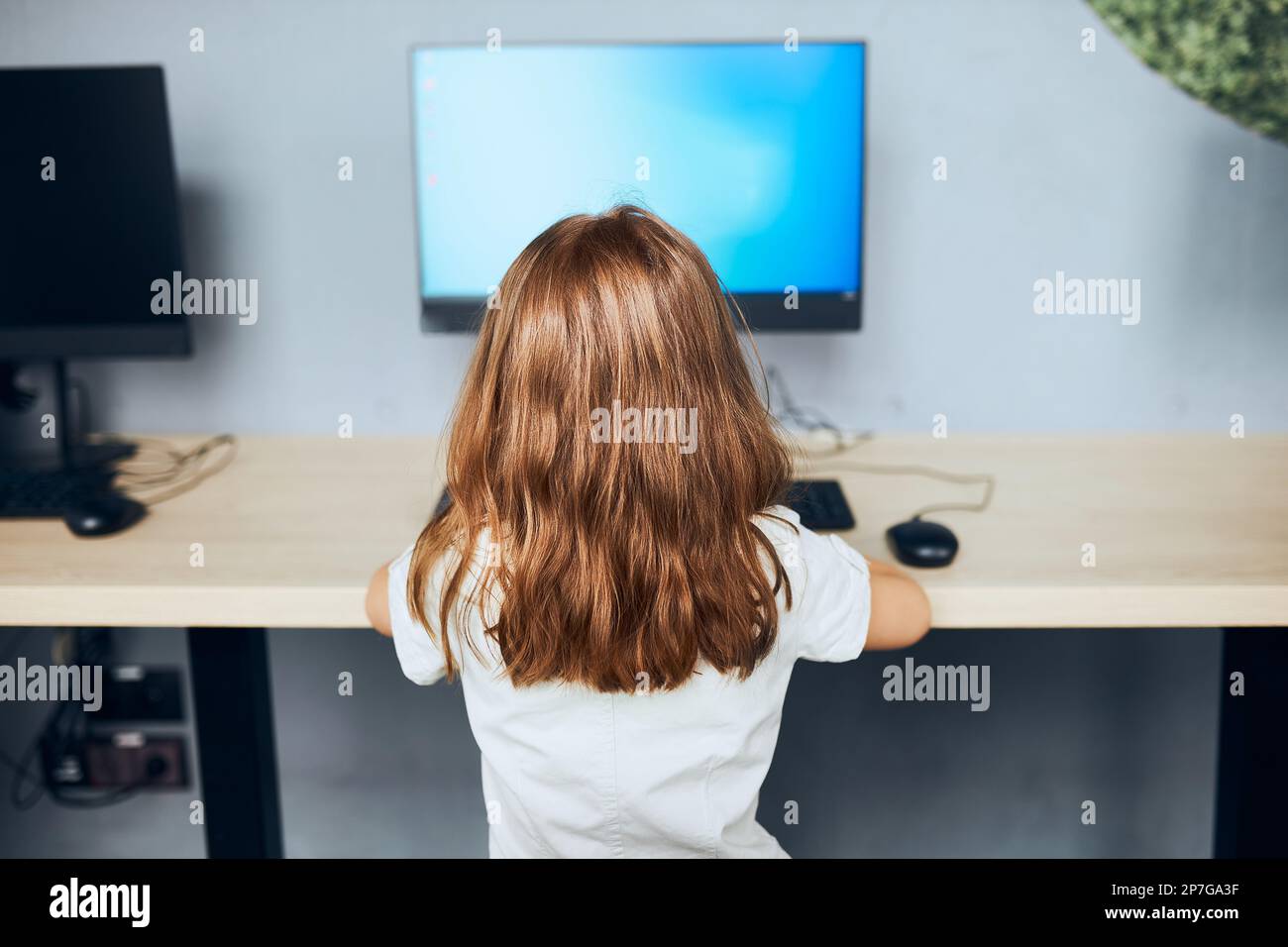 Child learning to use technology in classroom at primary school ...