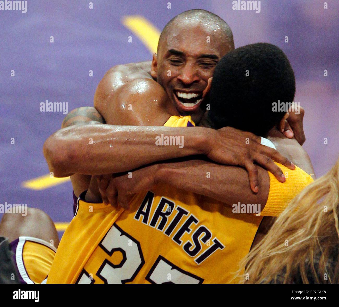 Los Angeles Lakers guard Kobe Bryant, rear, hugs forward Ron Artest ...