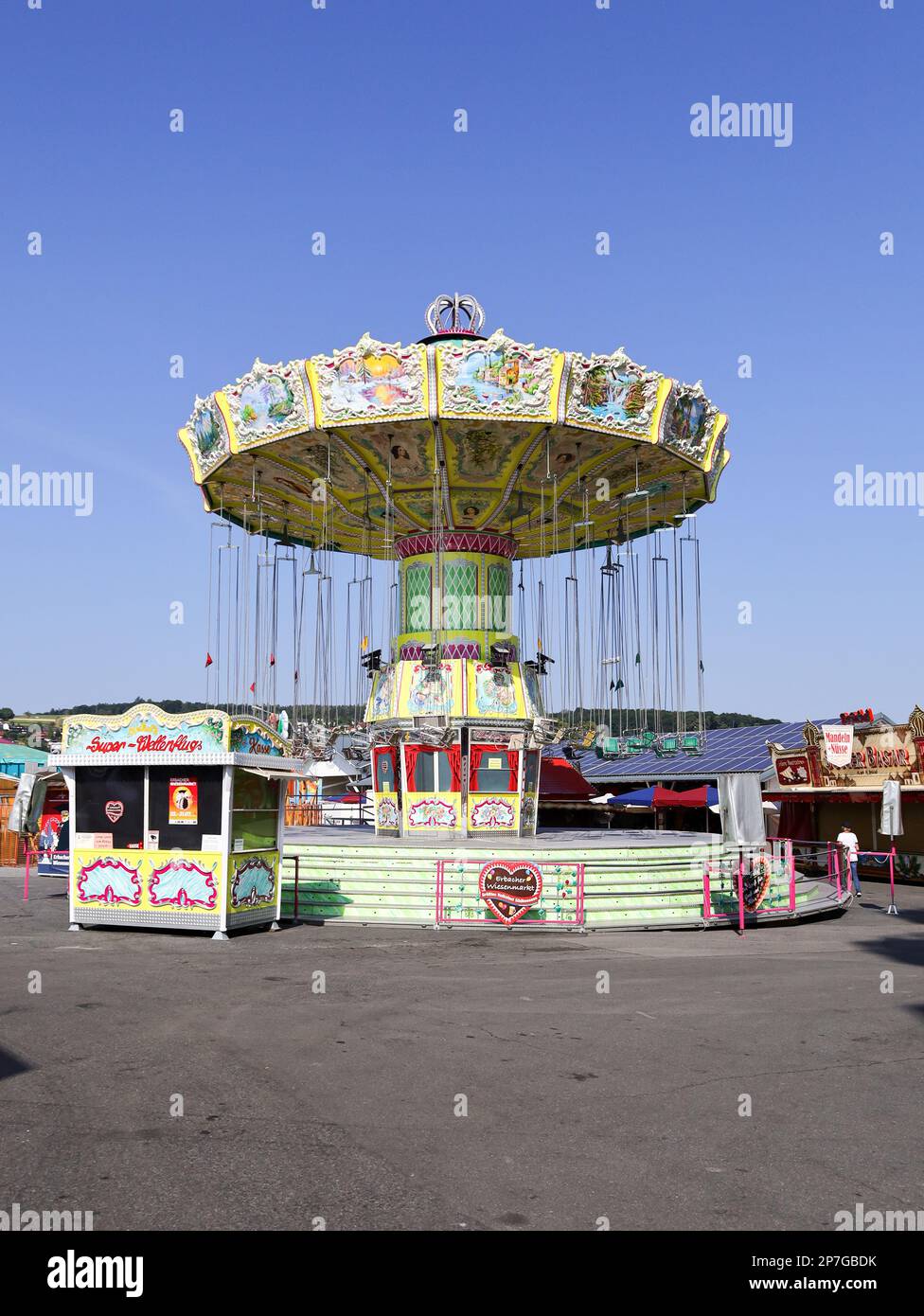 colorful booths and fun rides at a fairground Stock Photo - Alamy