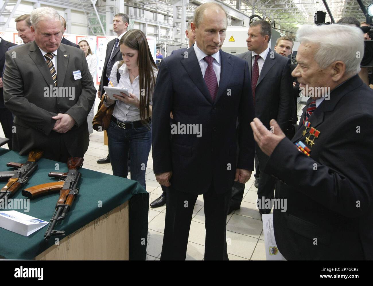 Russian Prime Minister Vladimir Putin, center, speaks with Mikhail ...