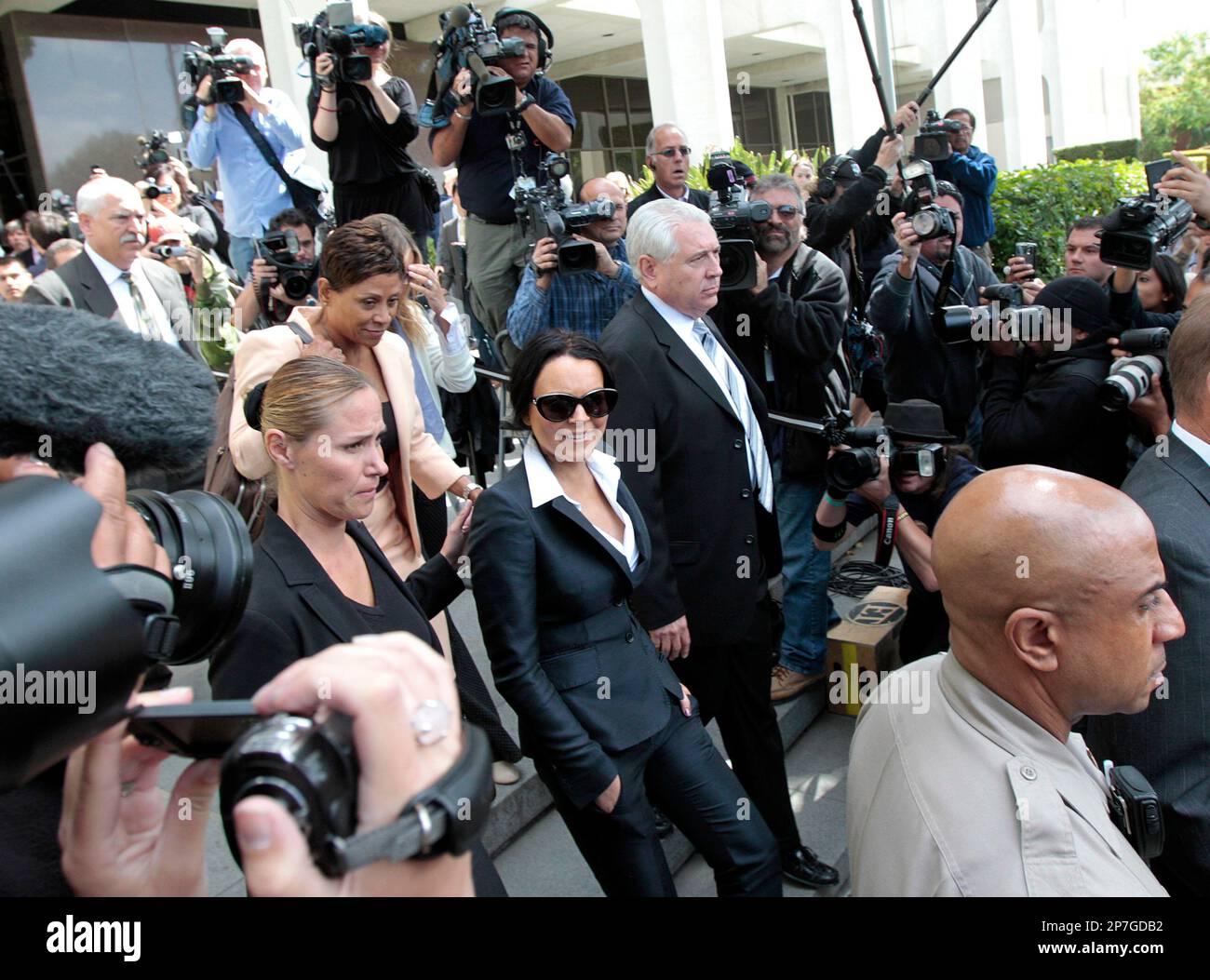 Actress Lindsay Lohan, center, smiles as she leaves Beverly Hills ...