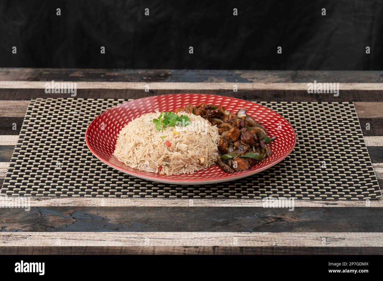 Chicken dry chili with a bowl of fried rice on textured background ...