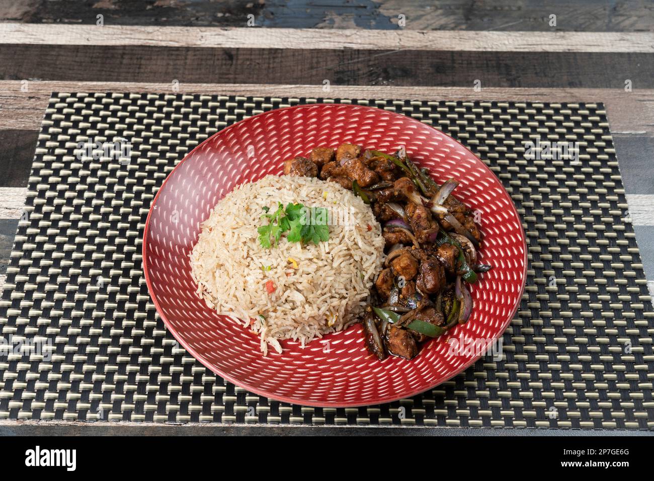 Chicken dry chili with a bowl of fried rice on textured background ...