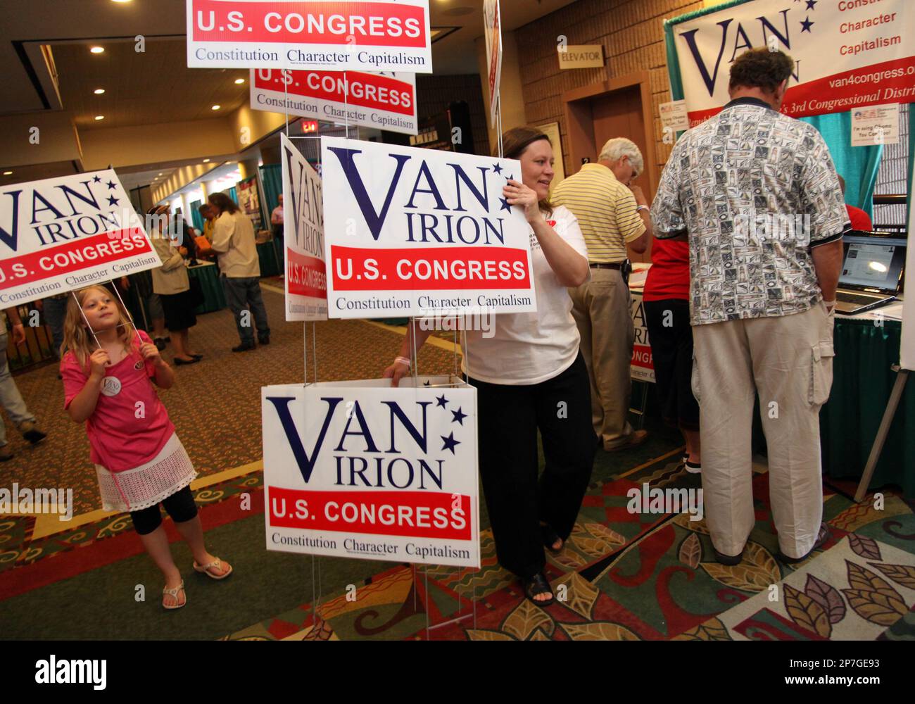 Dawn Irion , center, and daughter Natasha, 8, left, organize signs for ...