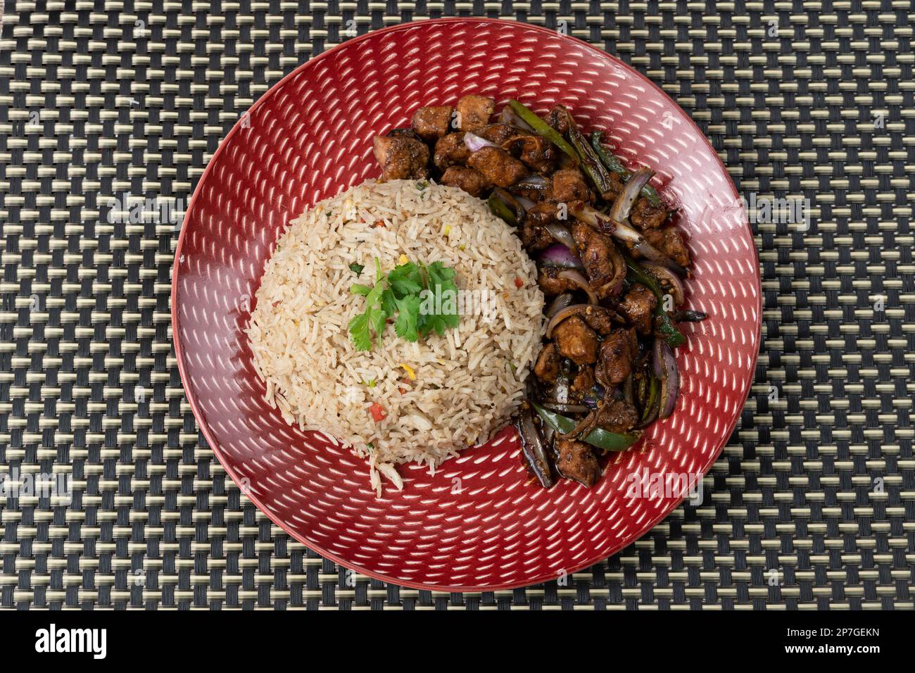 Chicken dry chili with a bowl of fried rice on textured background ...