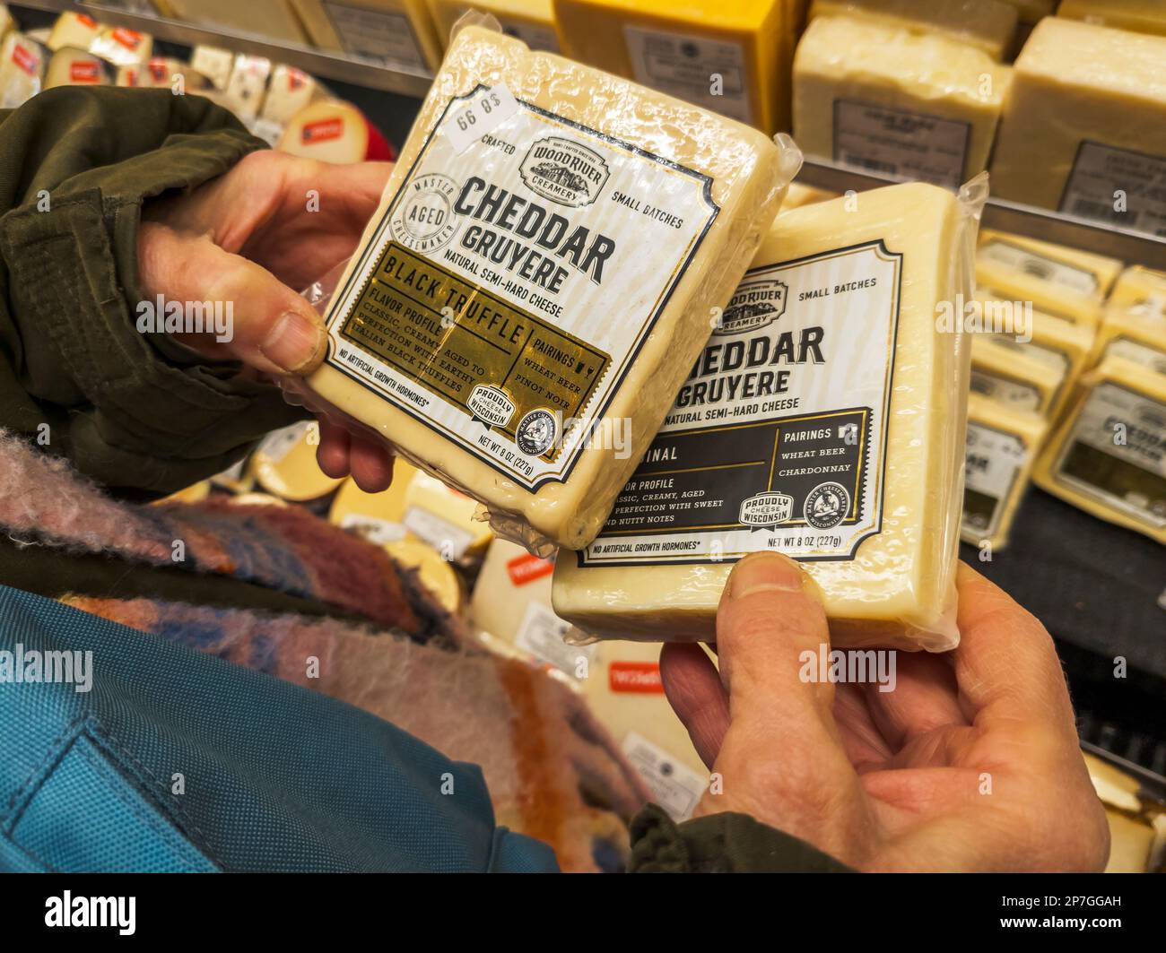A shopper chooses packages of domestic Wood River Creamery brand ...