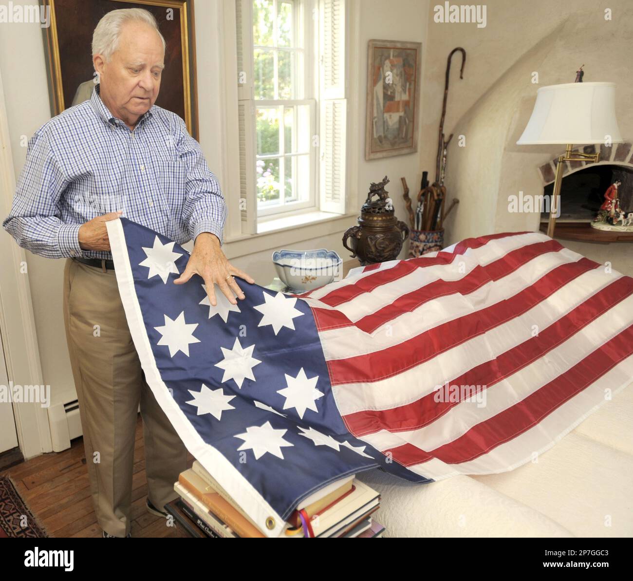 In a May 10, 2010 photo, Rev. Richardson Libby, a flag historian, using ...