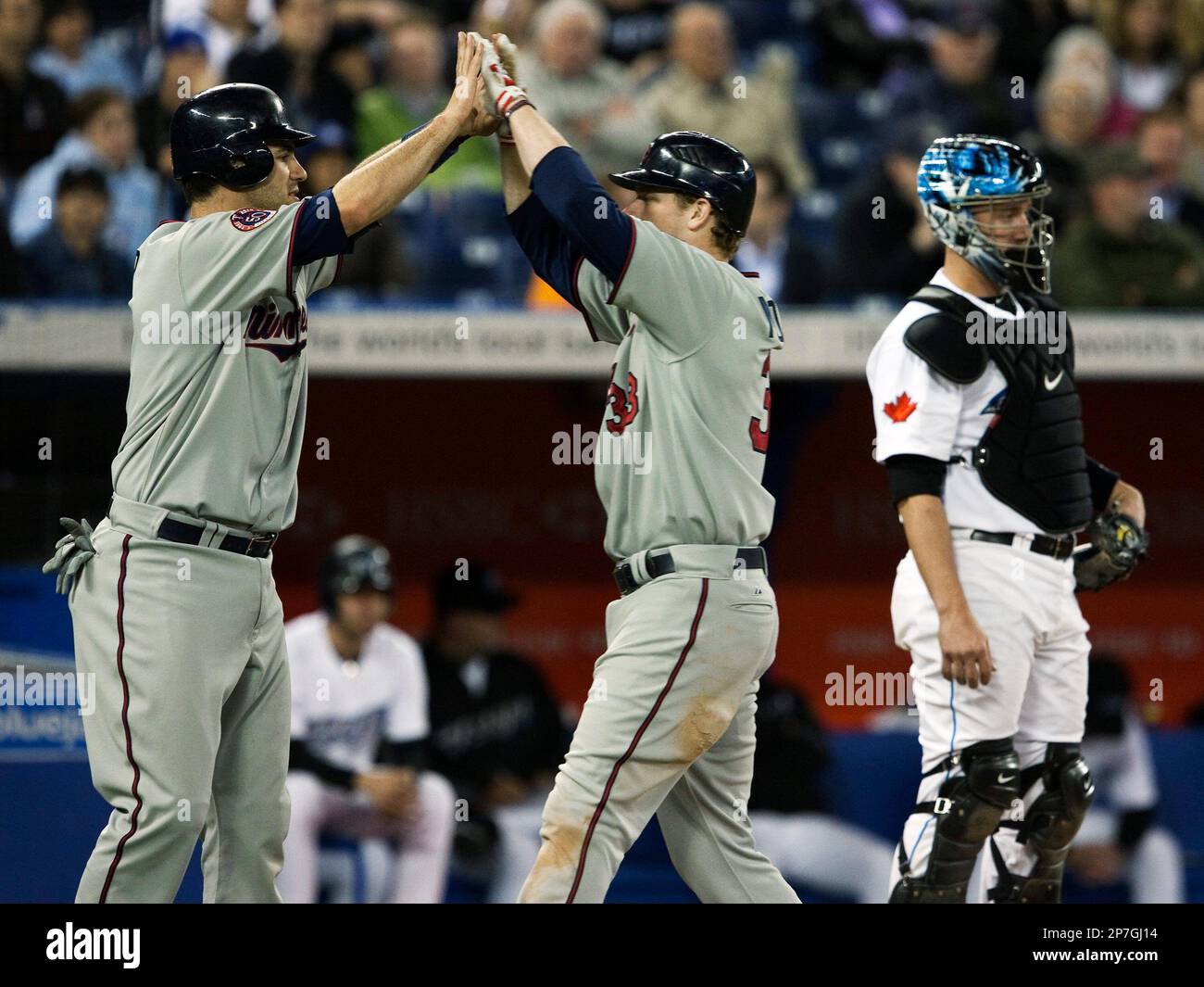 Minnesota Twins catcher Joe Mauer, left, celebrates the Twins first ...