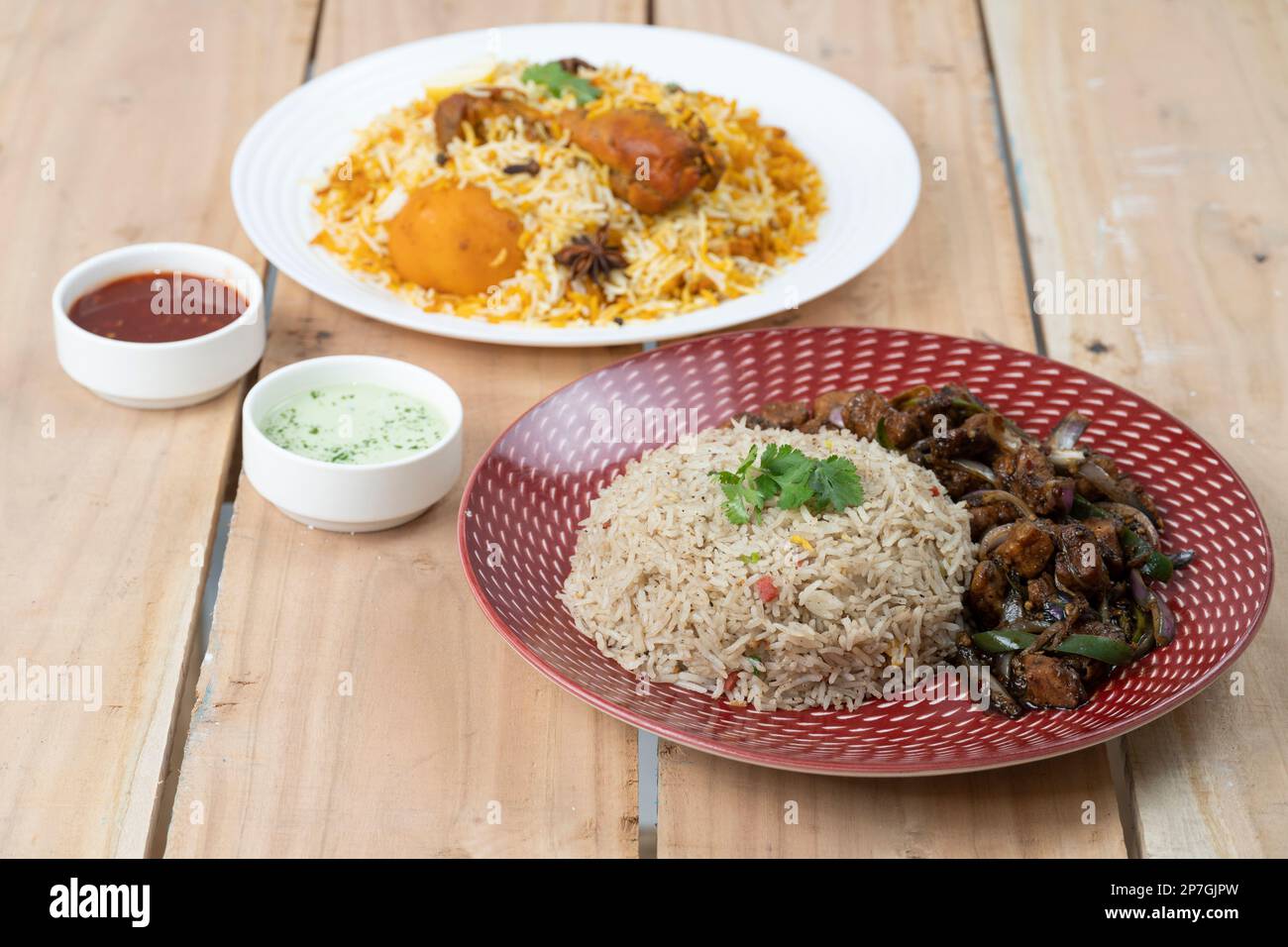 Chicken dry chili with a bowl of fried rice along with biryani and ...