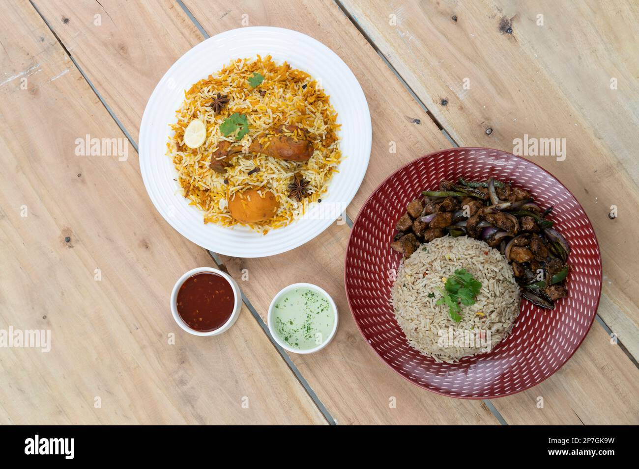 Chicken dry chili with a bowl of fried rice along with biryani and ...