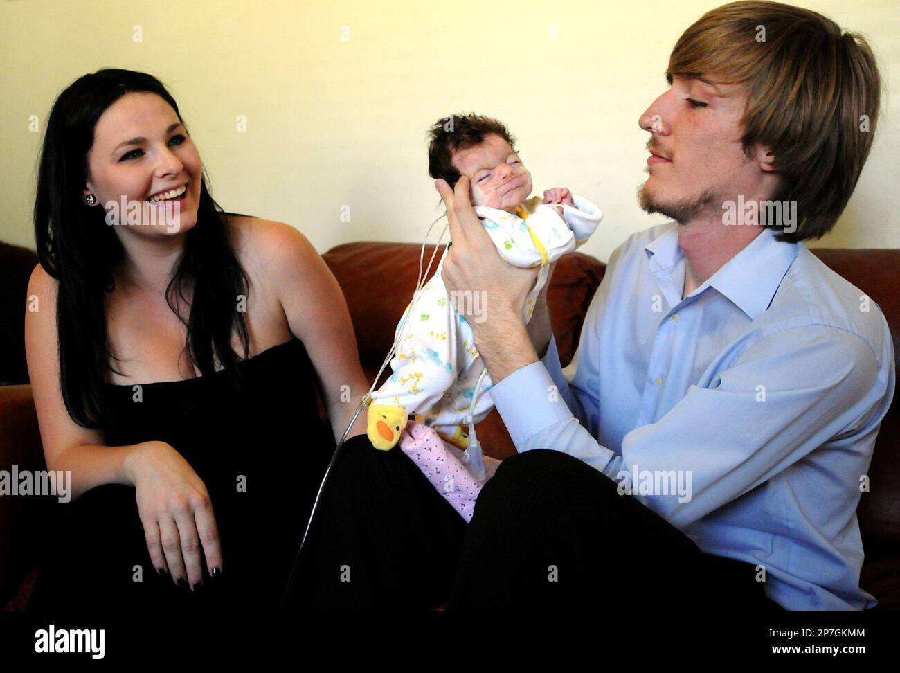 Blair Flint smiles while her husband Sidney holds Cambria on the couple ...