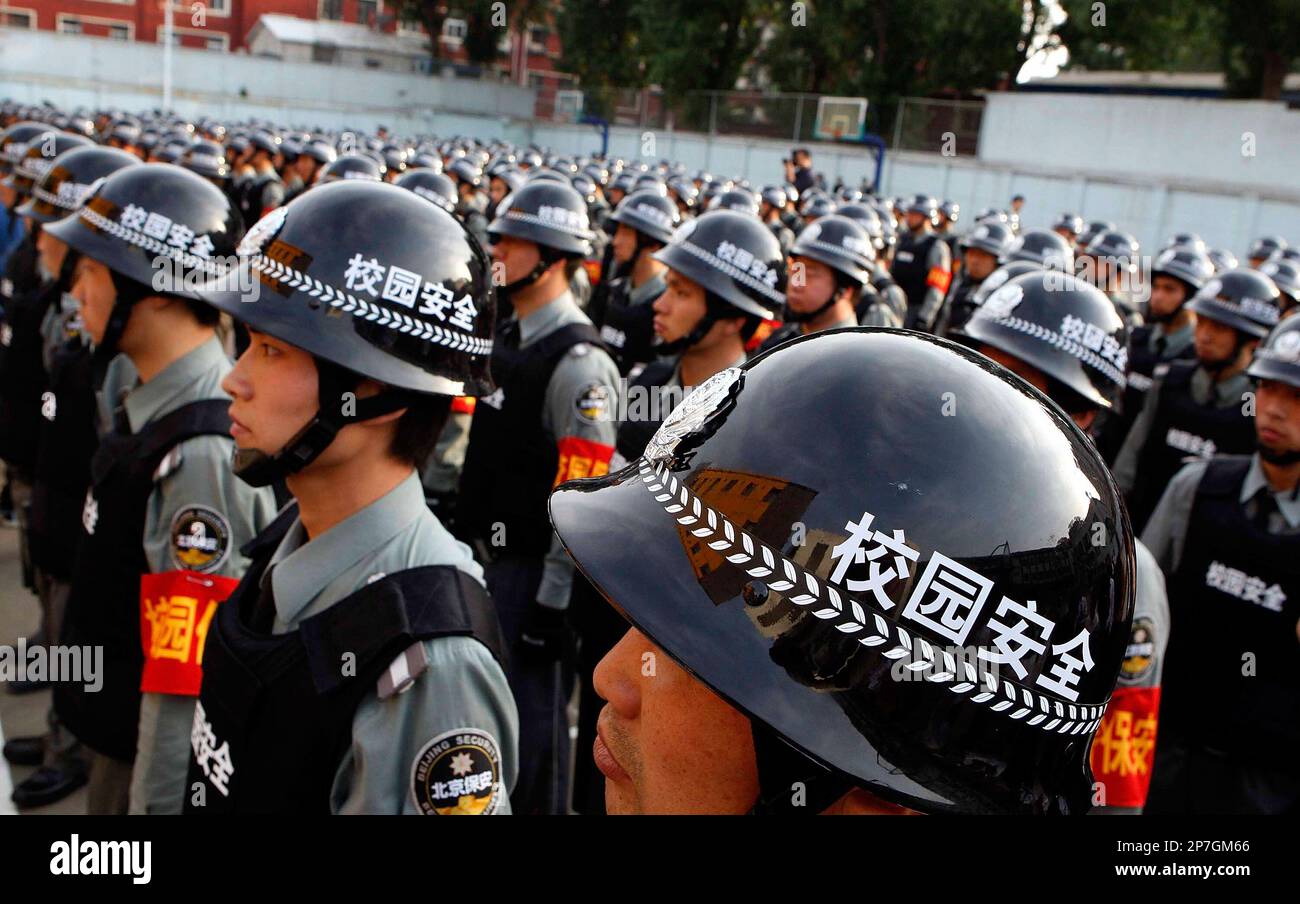 School security members stand in lines during a launch ceremony in ...
